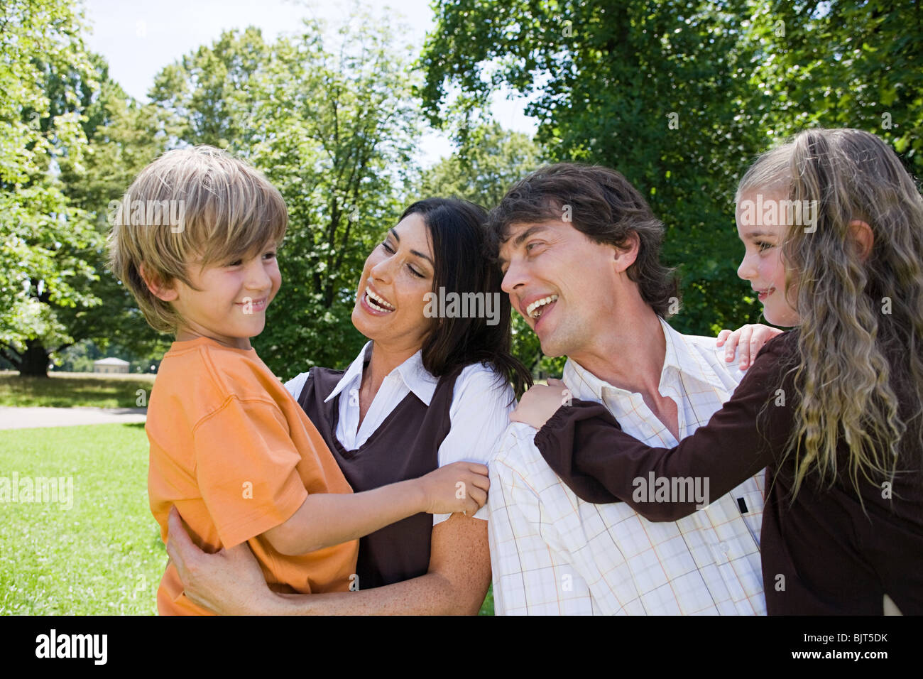 Happy family in park Stock Photo - Alamy