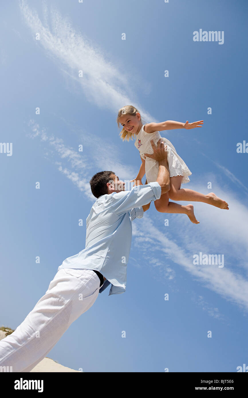 Man lifting daughter Stock Photo - Alamy