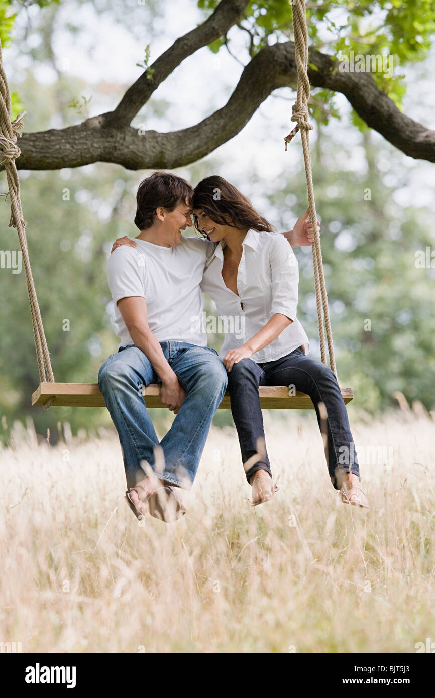 Couple sitting on swing hi-res stock photography and images - Alamy
