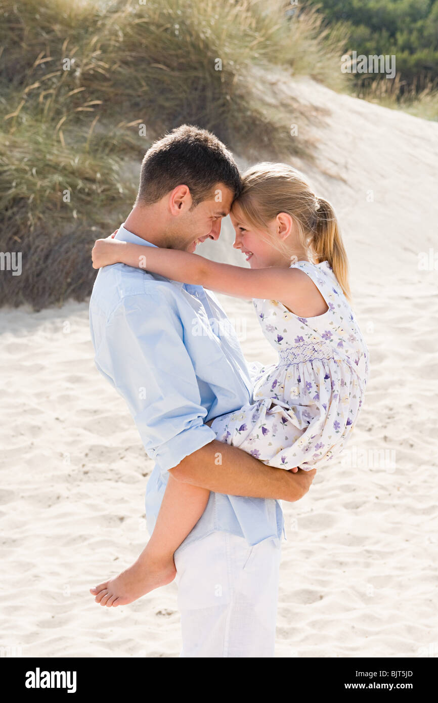 Father carrying daughter Stock Photo - Alamy