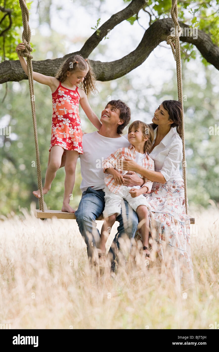 Family on a swing Stock Photo - Alamy