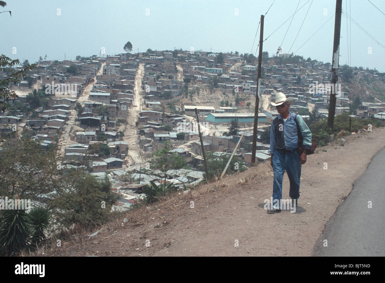 HONDURAS MAN WALKING BY SHANTY TOWNS OF TEGUCIGALPA Stock Photo - Alamy