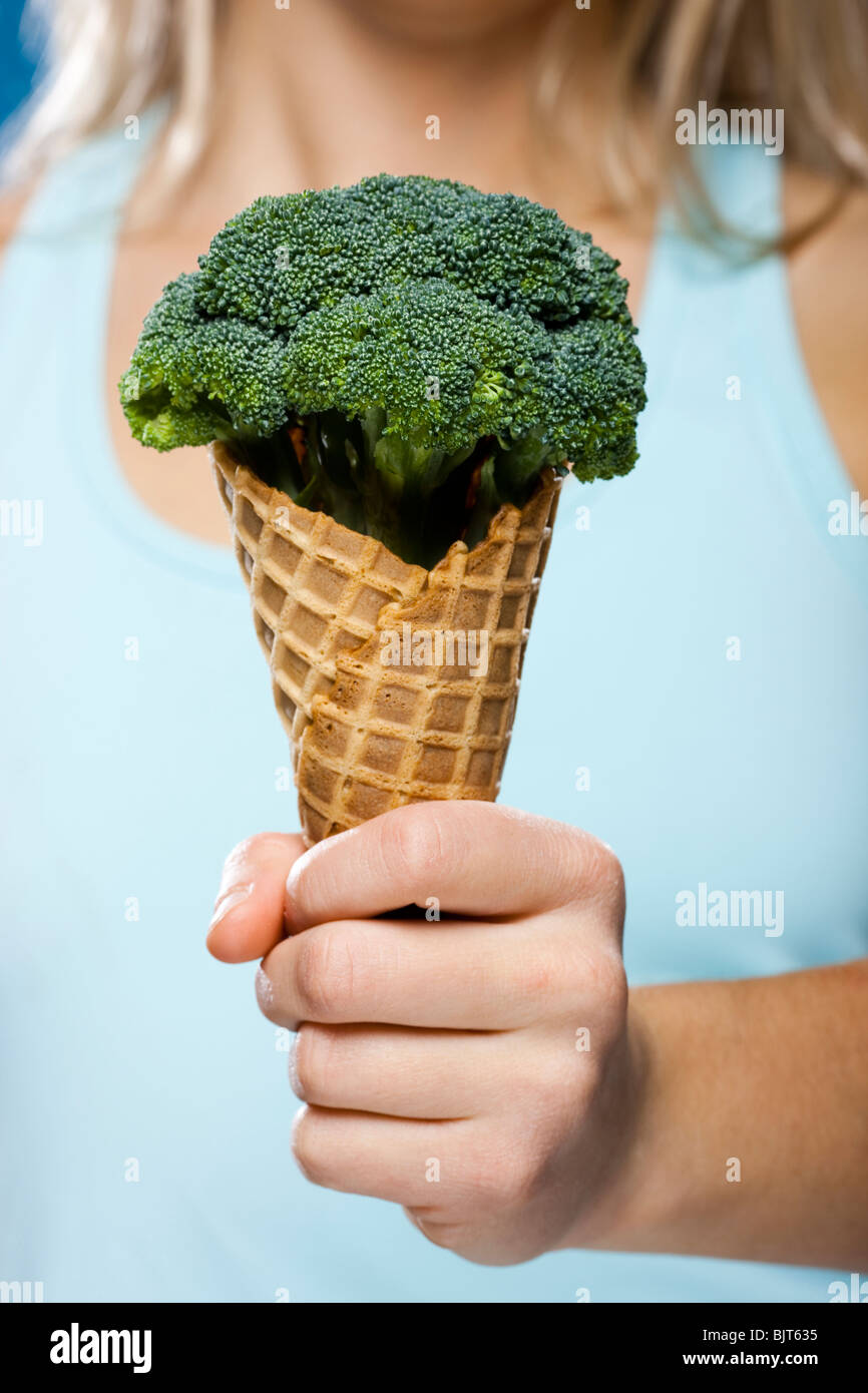Young woman holding broccoli ice cream Stock Photo - Alamy