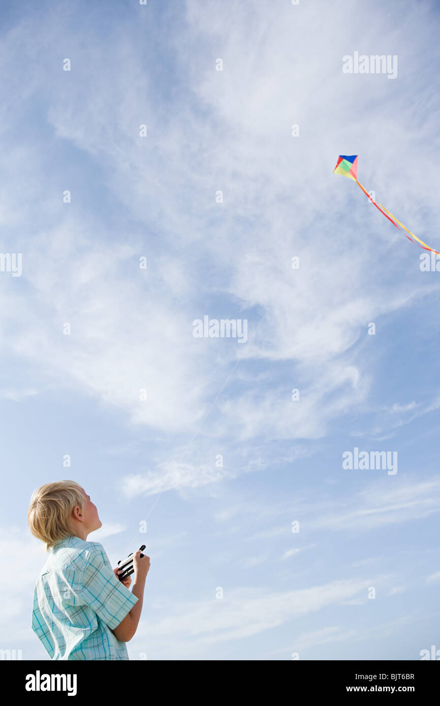A boy flying a kite Stock Photo - Alamy