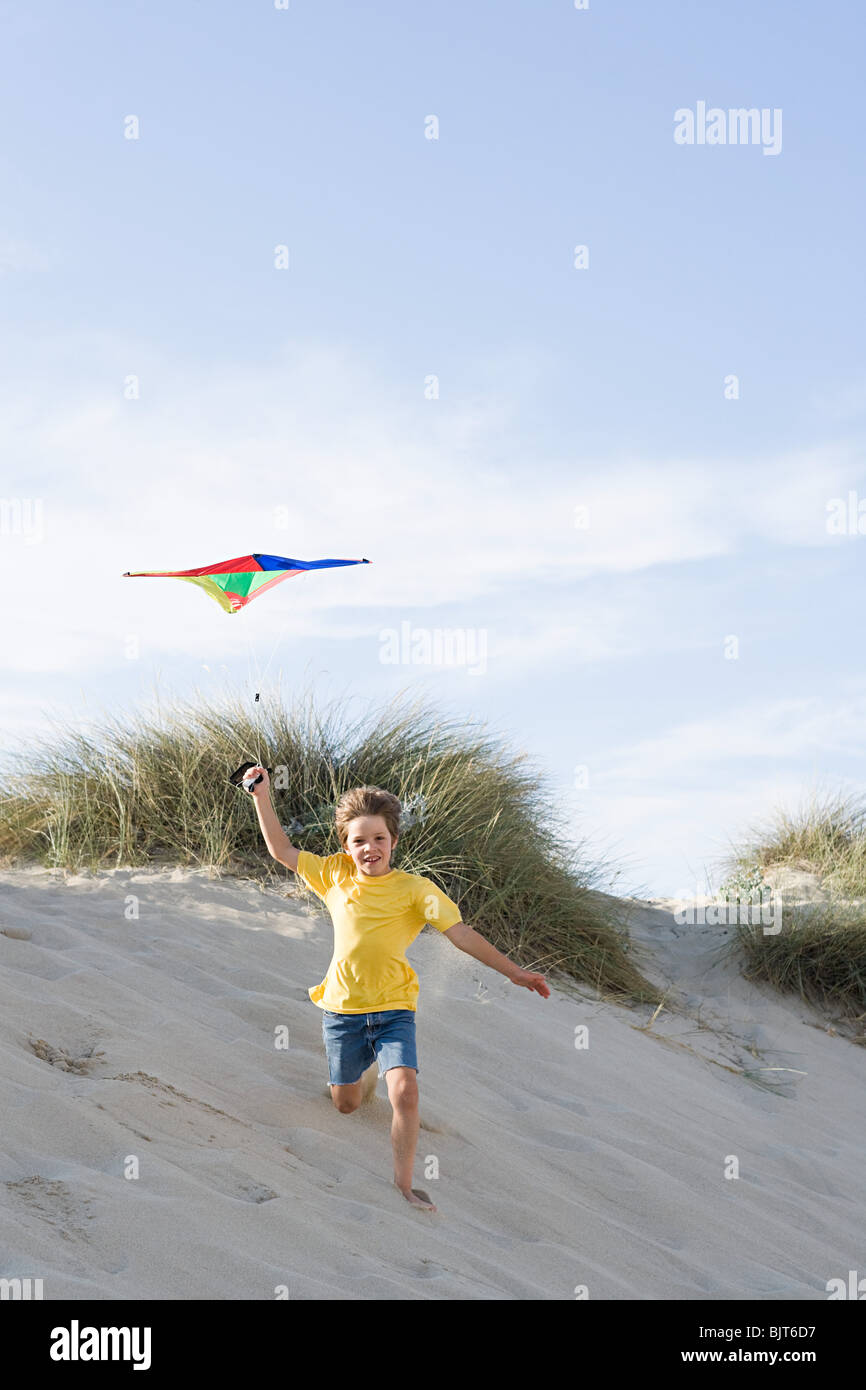 A boy flying a kite Stock Photo - Alamy