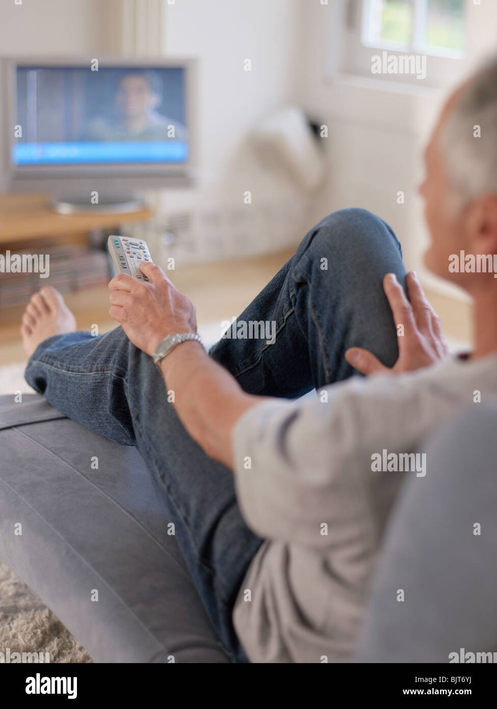 A man watching tv Stock Photo - Alamy