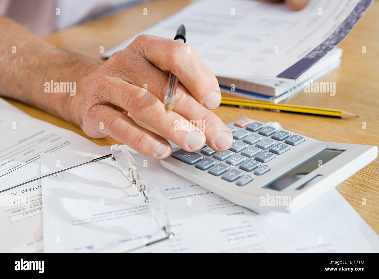 Using a calculator hi-res stock photography and images - Alamy