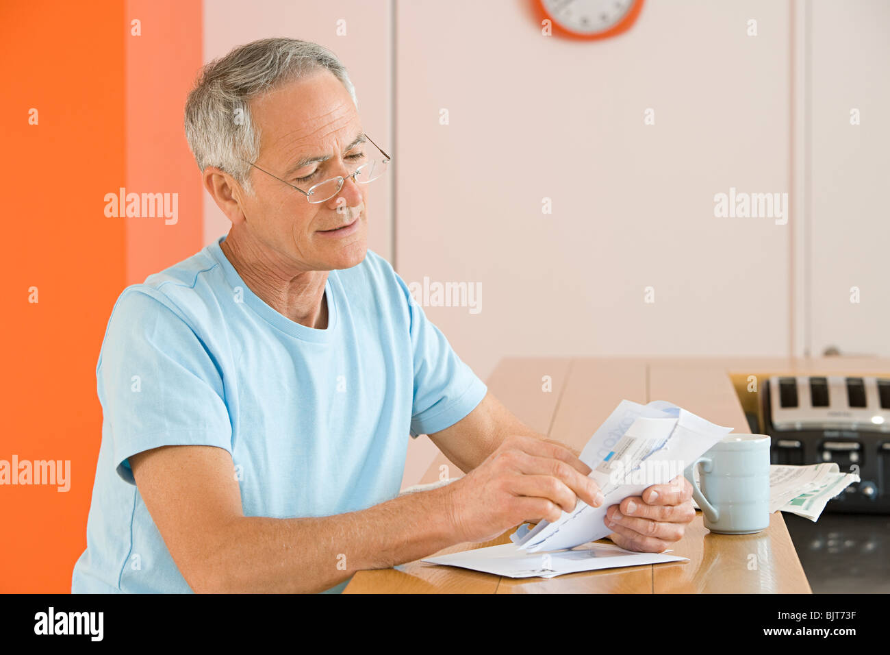 A man opening his mail Stock Photo - Alamy