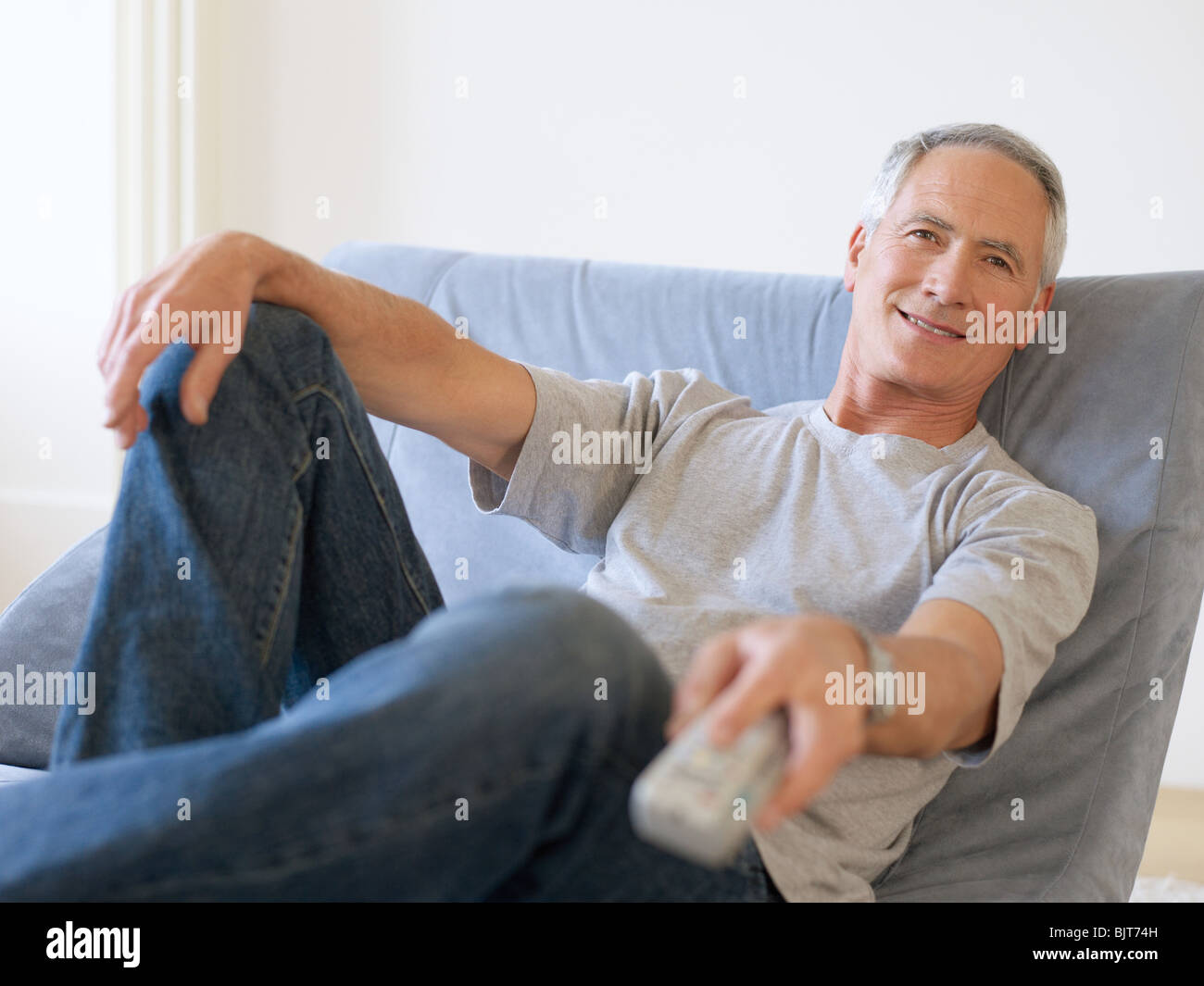 A man watching tv Stock Photo - Alamy