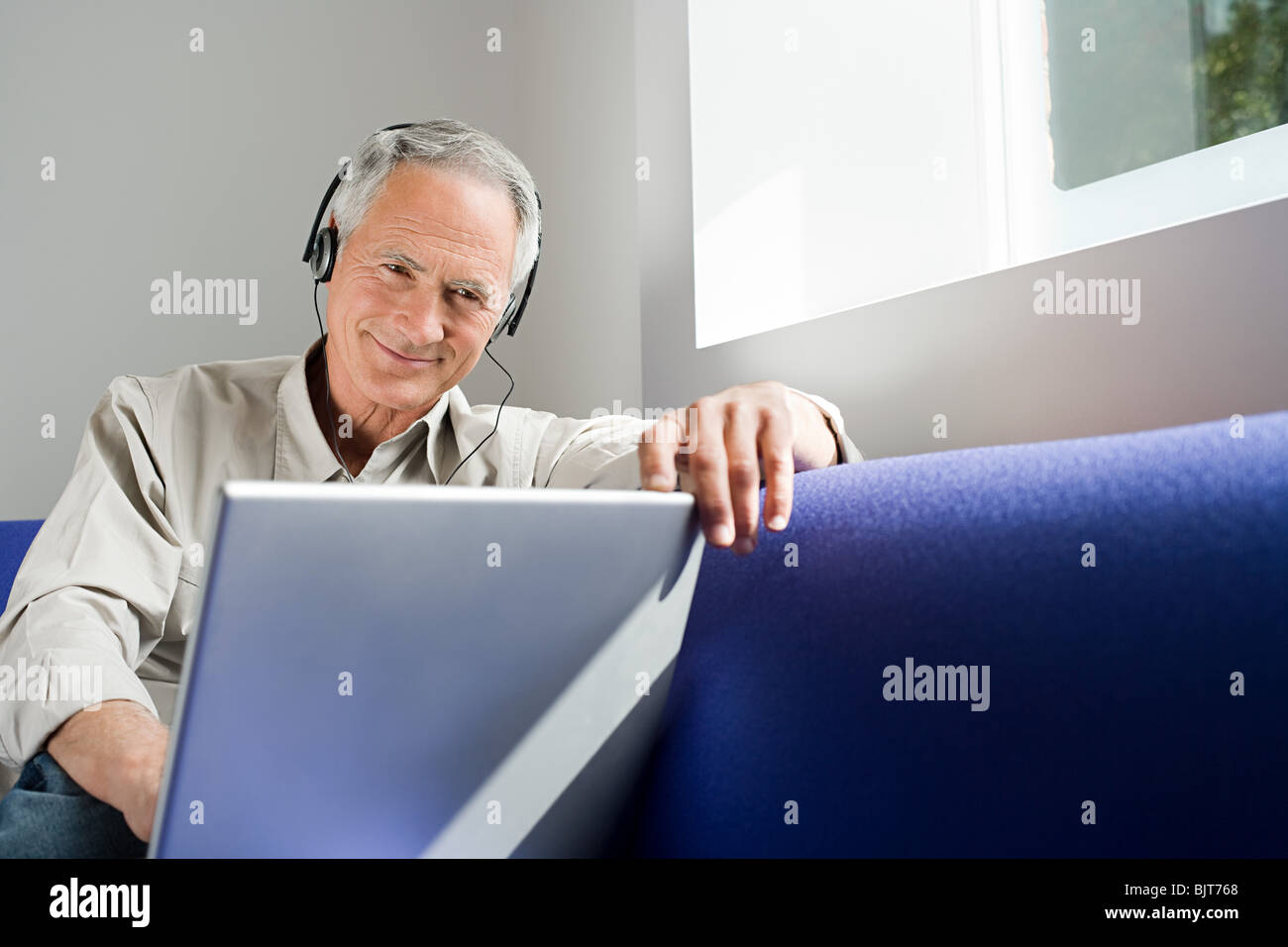 A man watching his laptop Stock Photo - Alamy