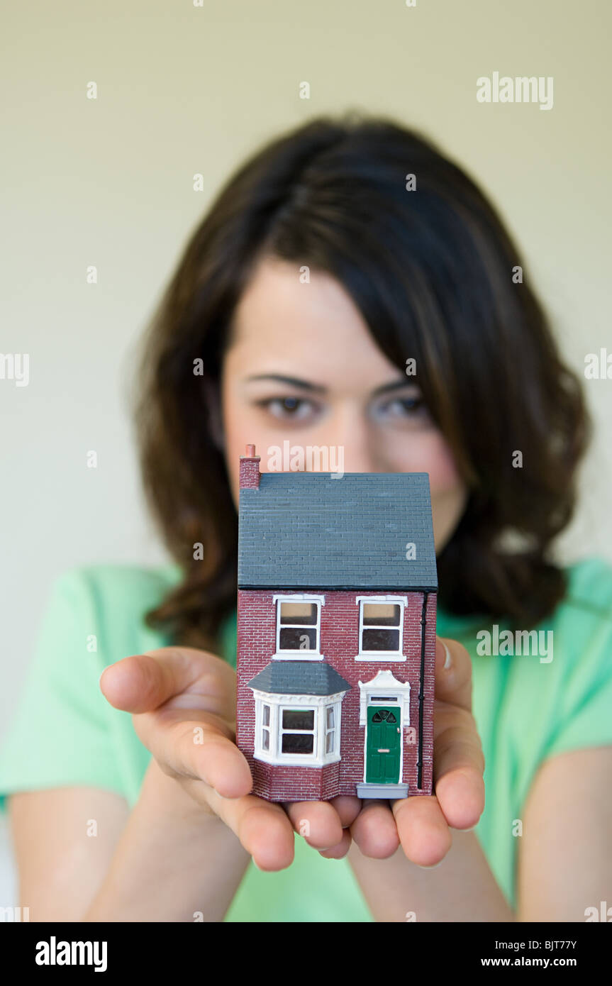 Young woman holding house model hi-res stock photography and images - Alamy