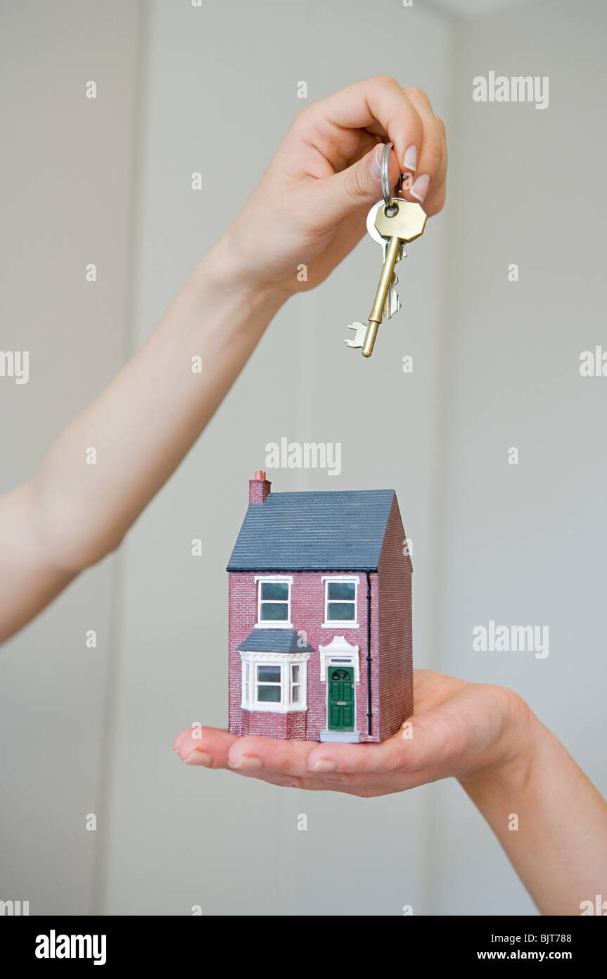 People holding keys and house Stock Photo - Alamy