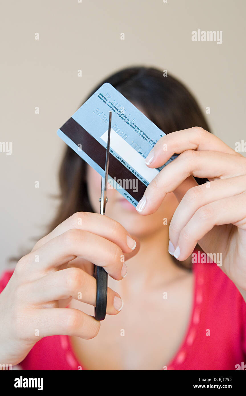Woman cutting credit card Stock Photo - Alamy
