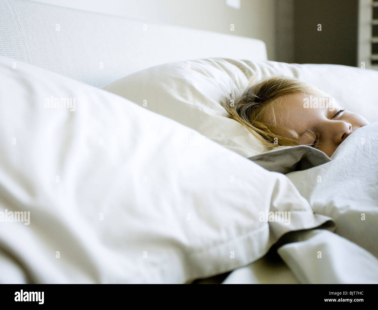 Girl sleeping under covers hi-res stock photography and images - Alamy