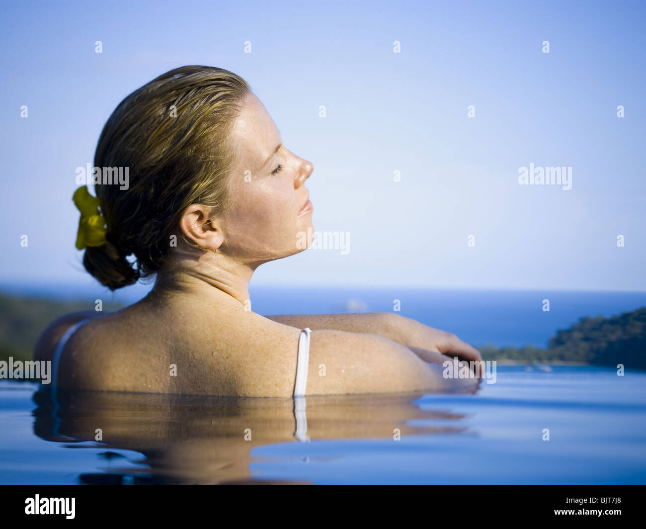 Rear view of a young woman in a swimming pool Stock Photo - Alamy