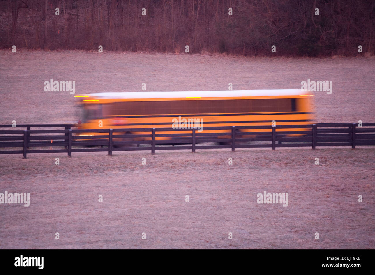School bus in the early morning making a stop to pick up students ...