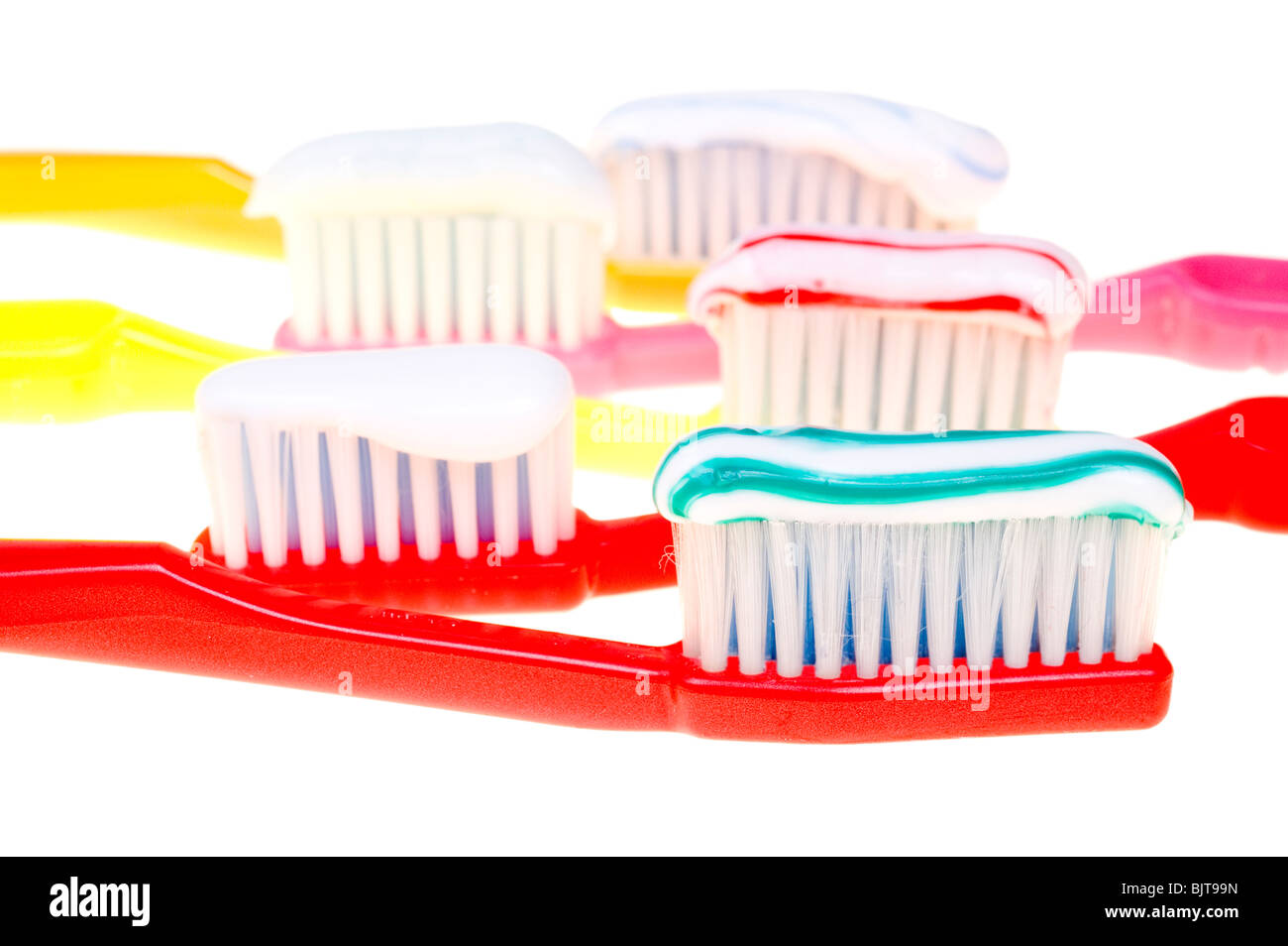 Colorful brushes with color toothpaste isolated on white background ...