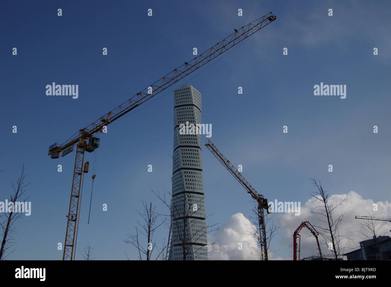Turning Torso building between the cranes Stock Photo - Alamy