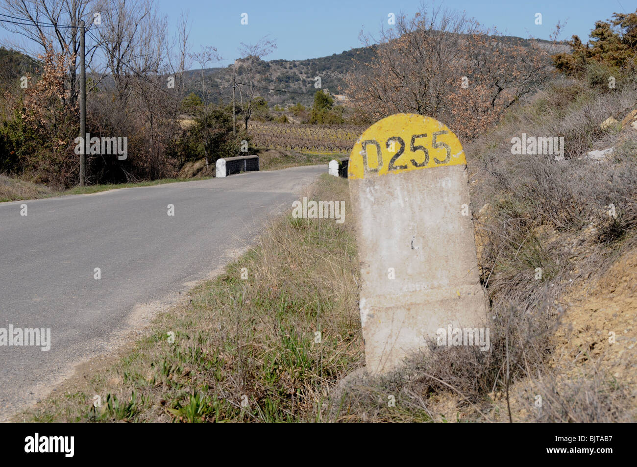 A roadside kilometre stones at the side of a rural French road. These ...