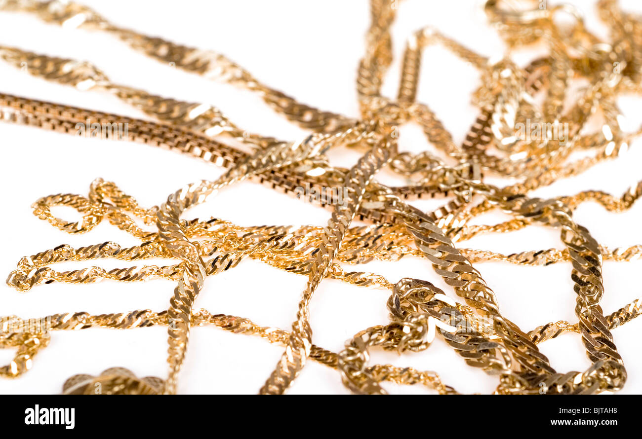 Gold chains close up isolated on white background Stock Photo - Alamy