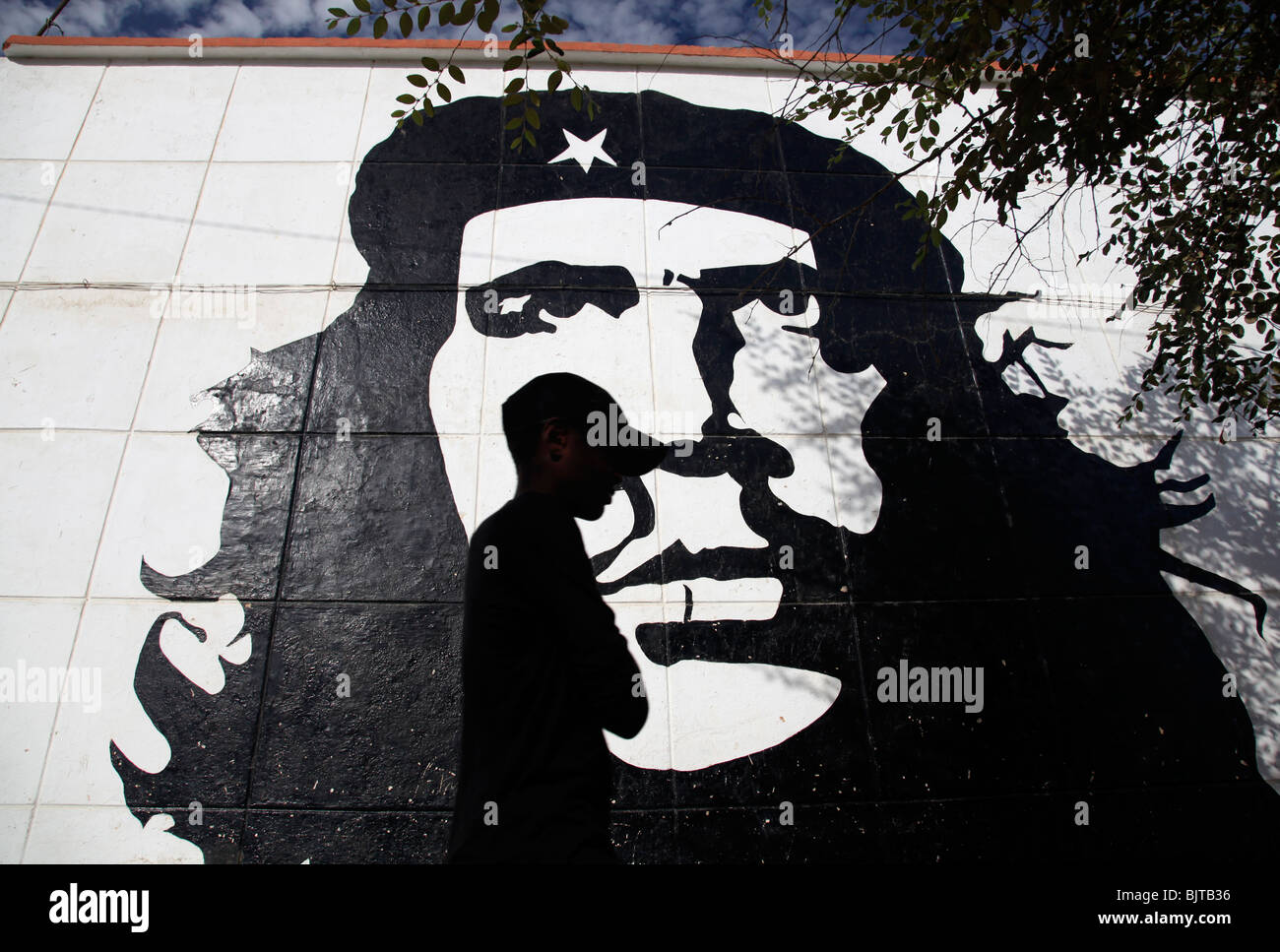 Angolans walk past the Che Guevara mural in the centre of sumbe. Sumbe ...