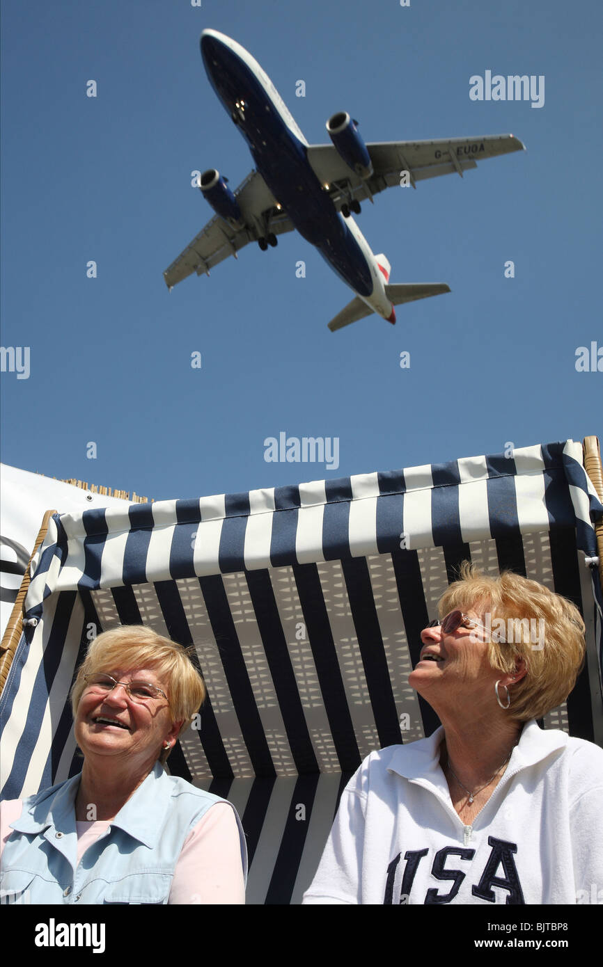 Plane flying over people's heads, Berlin, Germany Stock Photo - Alamy