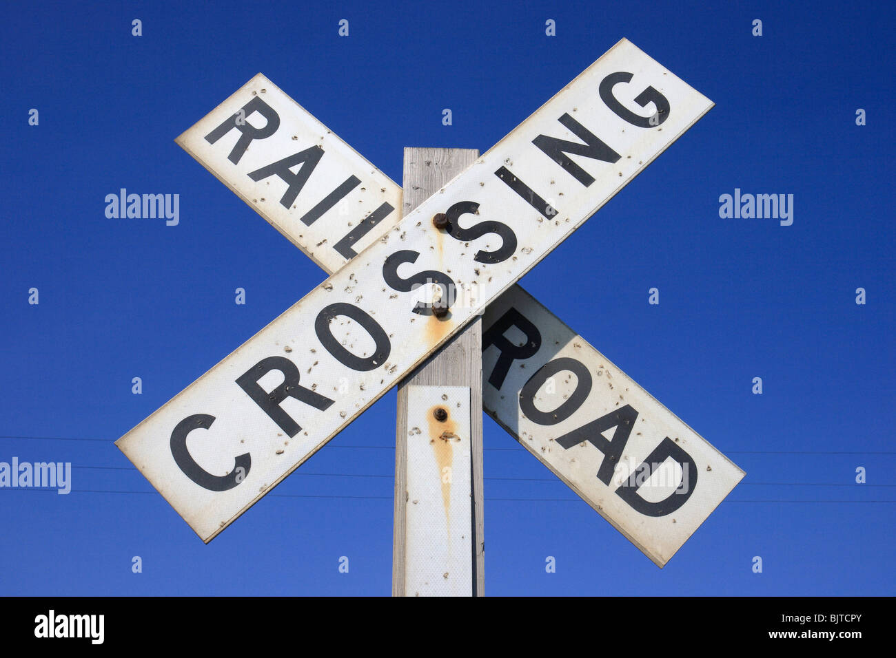 Signpost at a railroad crossing Stock Photo - Alamy