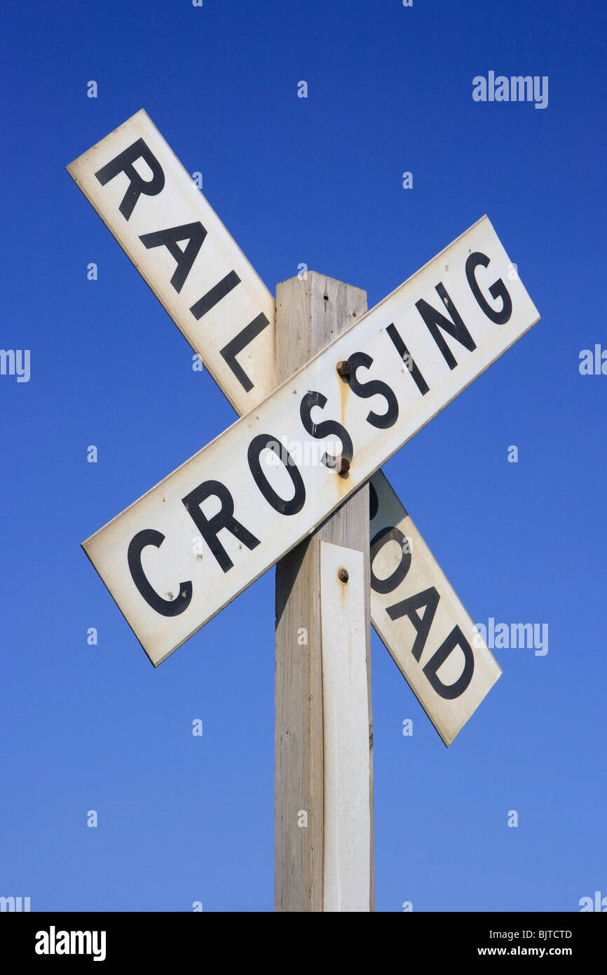 Signpost at a railroad crossing Stock Photo - Alamy