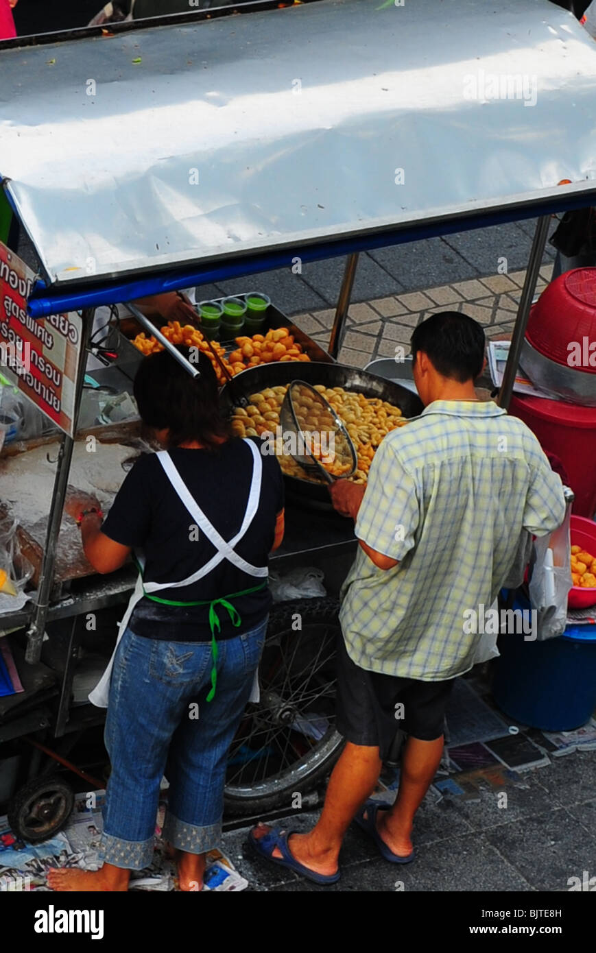 making and selling deep fried crispy thai bread rolls(PATONGKO),street ...