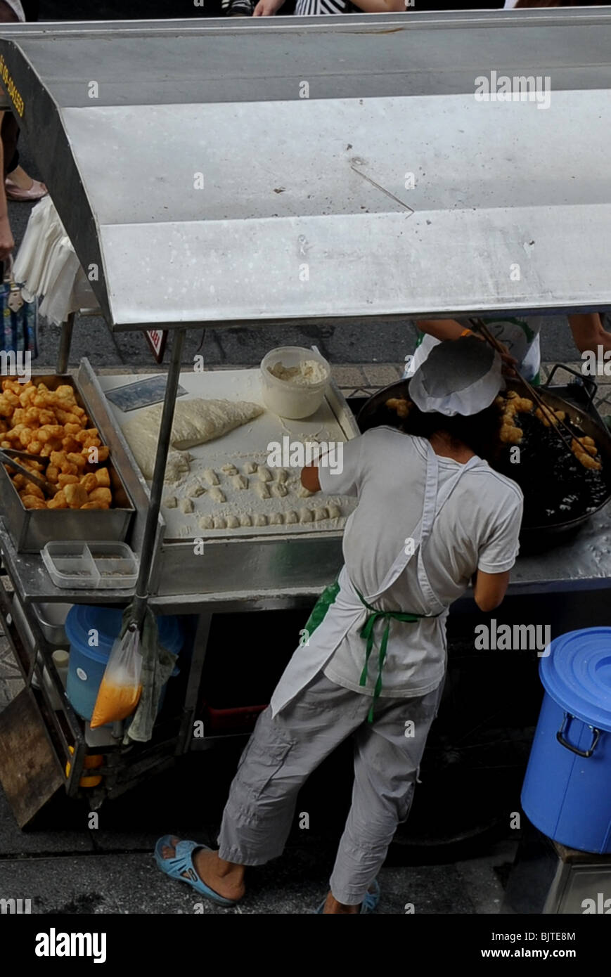 making and selling deep fried crispy thai bread rolls(PATONGKO),street ...