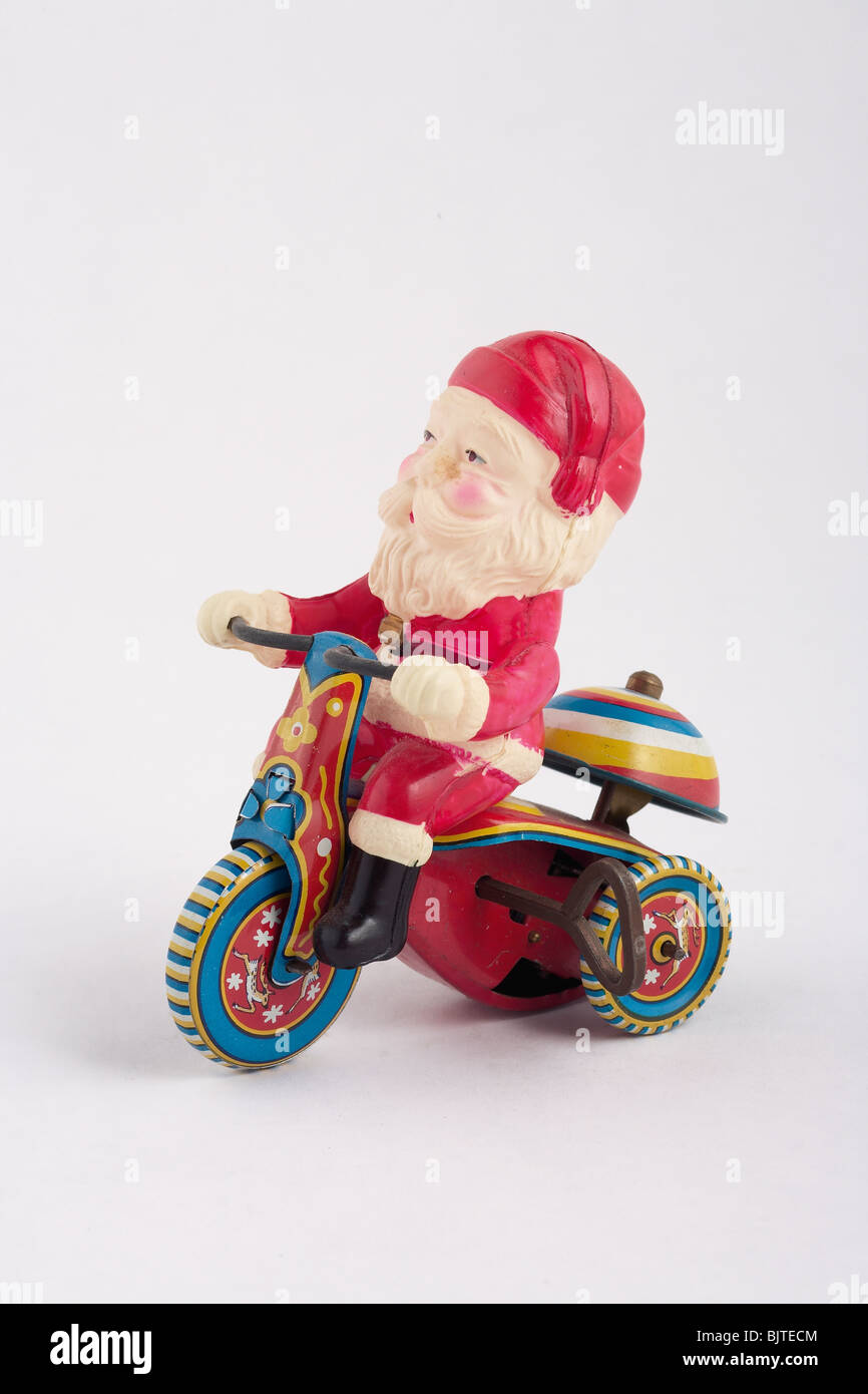 antique toy Santa riding metal tricycle with bell Stock Photo - Alamy