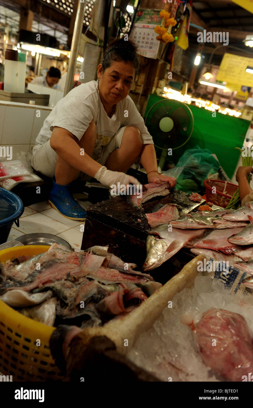 wet market , fresh fish being scaled ,Wongwian Yai Market and Bang Yi ...
