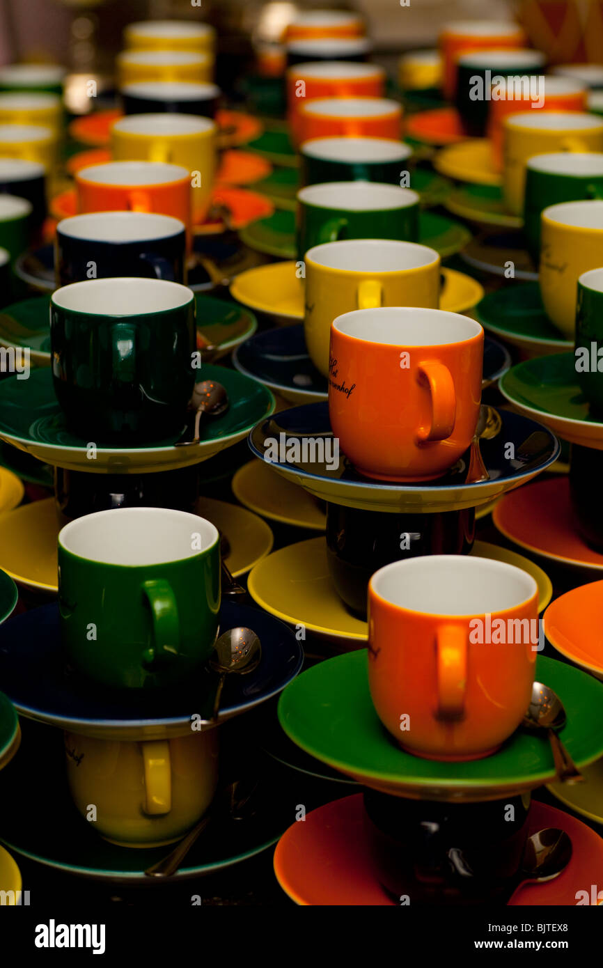 Stack of multi colored coffee mugs Stock Photo - Alamy