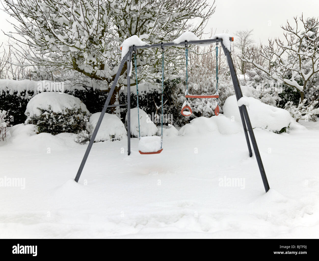 Swings In Thick Snow In Garden Surrey England Stock Photo - Alamy
