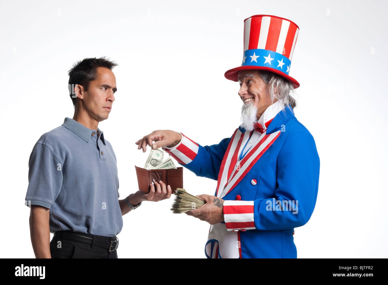 Man in Uncle Sam's costume taking money from other man, studio shot ...