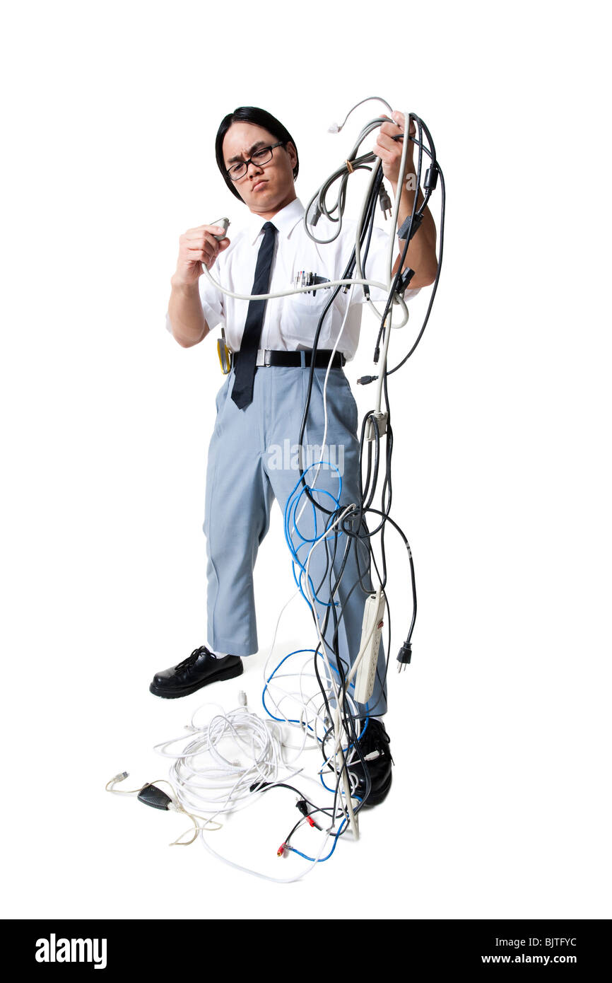 Office worker with tangled mess of wires Stock Photo - Alamy
