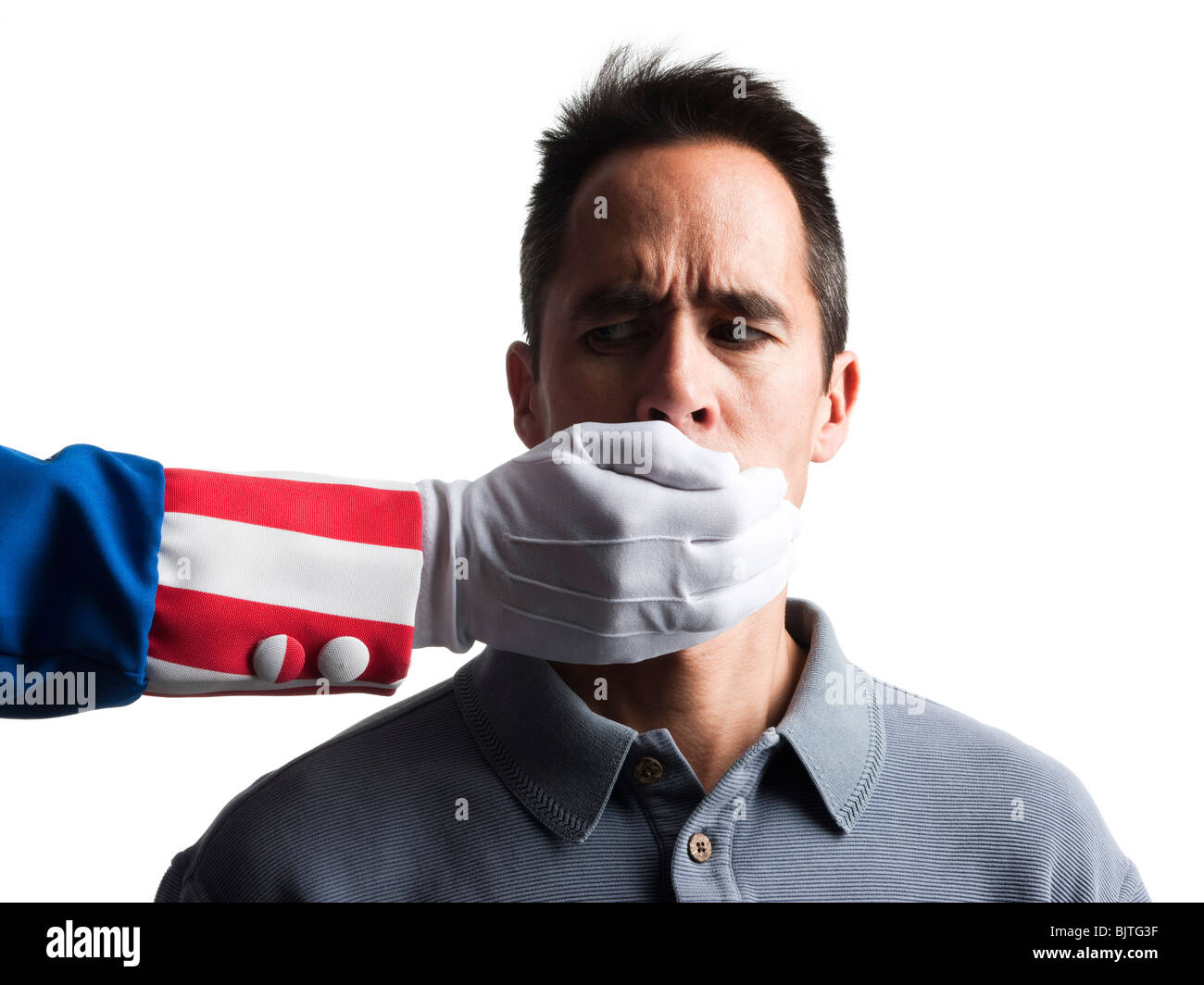 Human hand in Uncle Sam's costume shielding man's mouth, studio shot ...