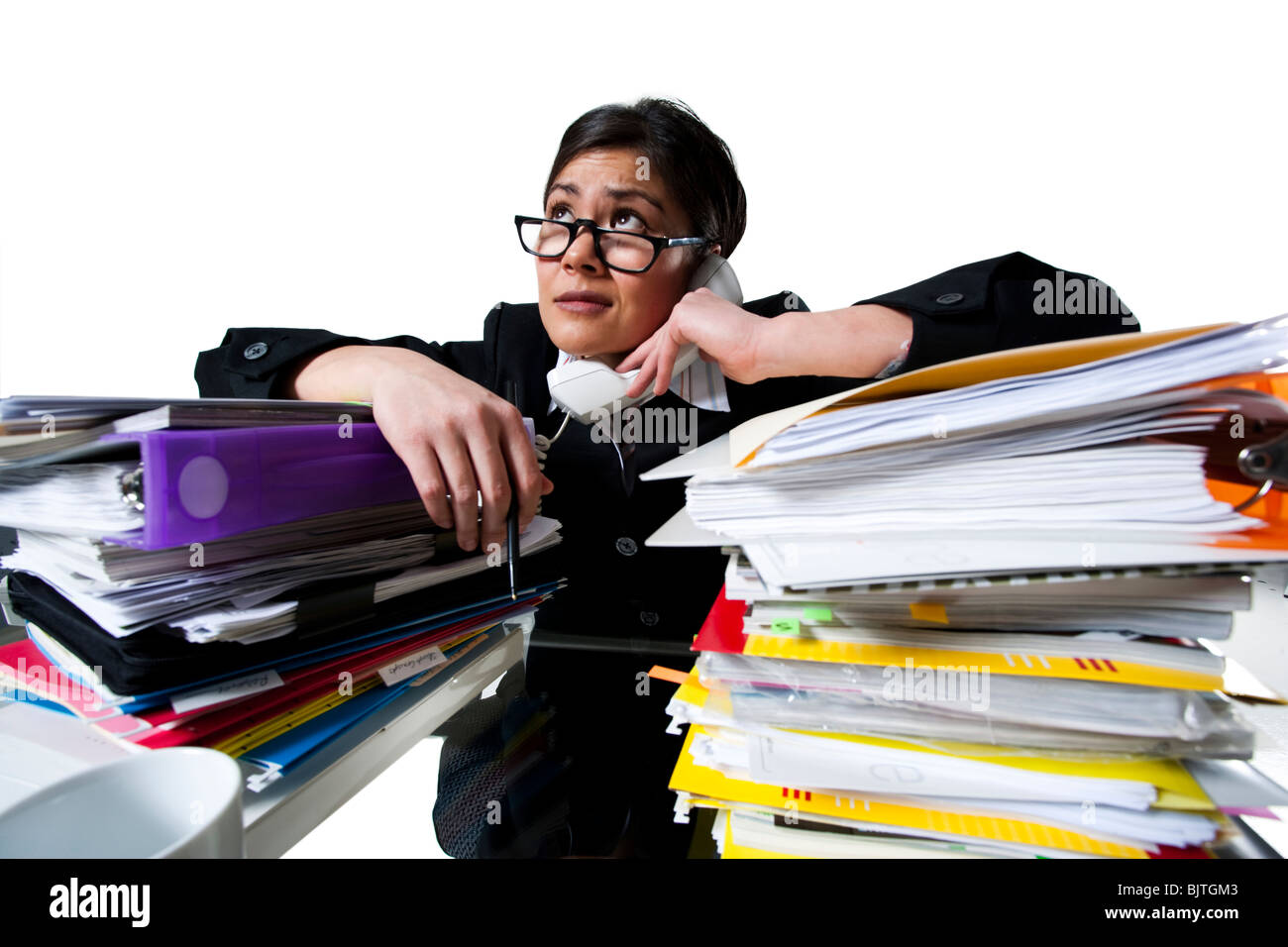 Woman on telephone with stack of binders Stock Photo - Alamy