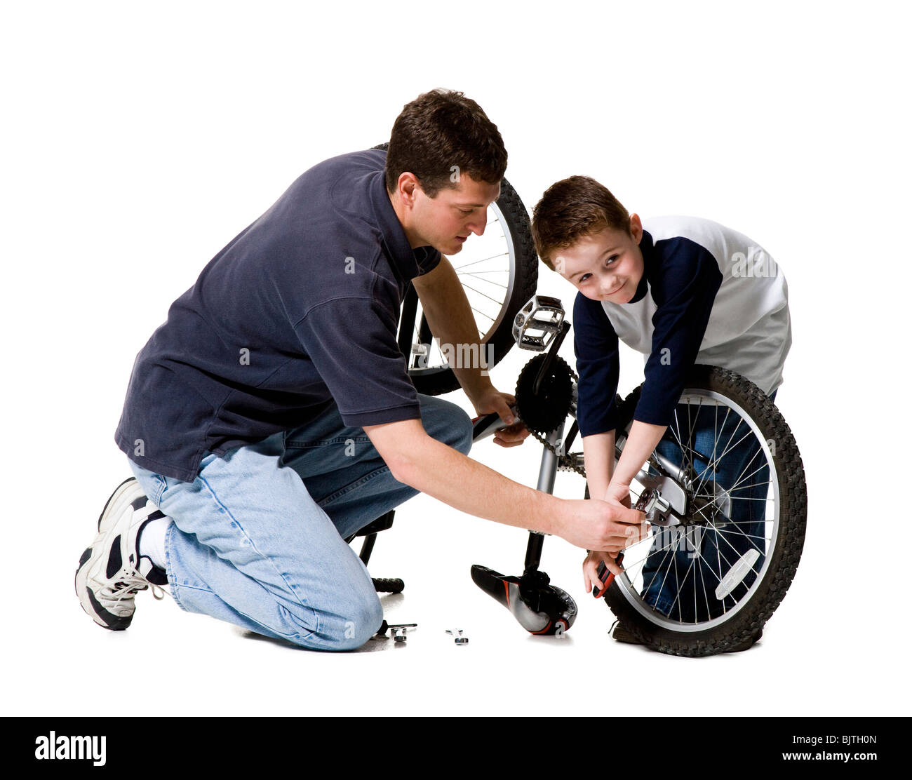Father with son repairing bicycle Stock Photo - Alamy