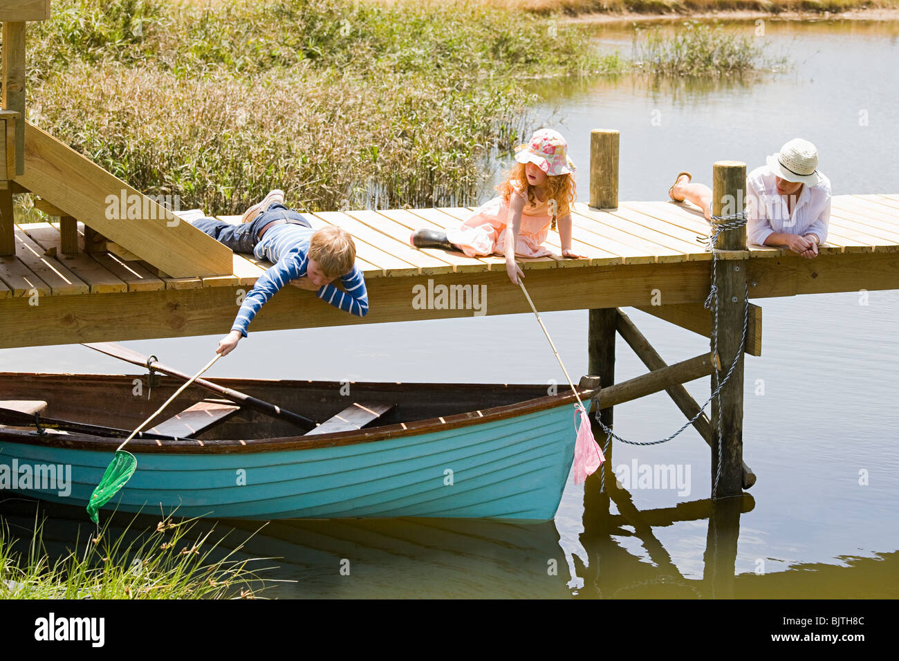Family enjoying lakeside vacation Stock Photo - Alamy