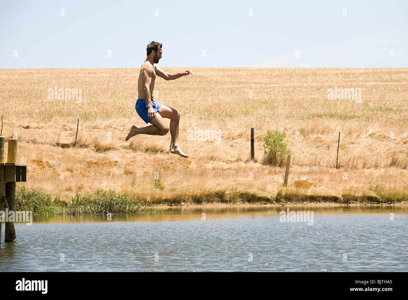 Man jumping into lake Stock Photo - Alamy