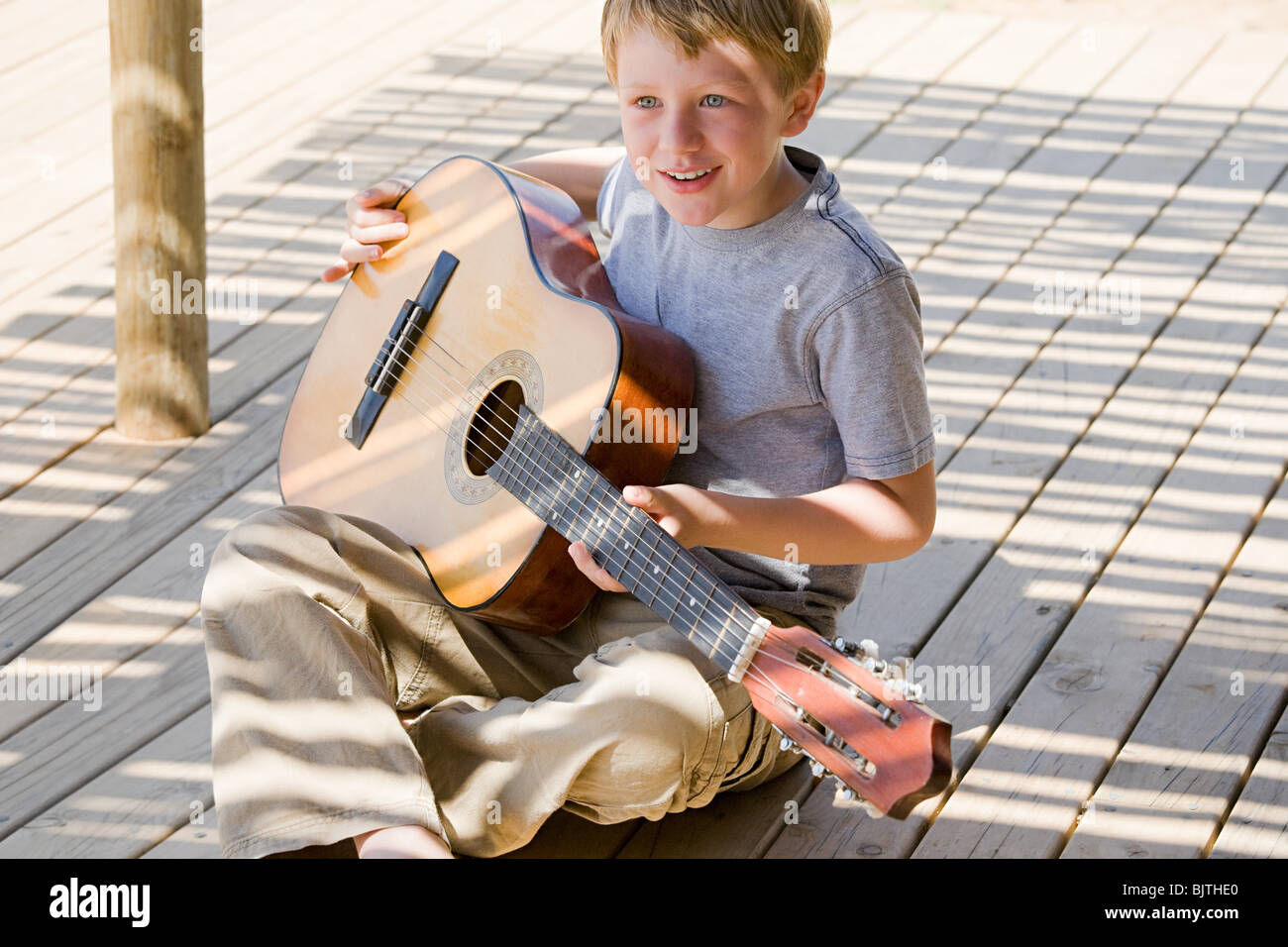 Boy playing guitar Stock Photo - Alamy