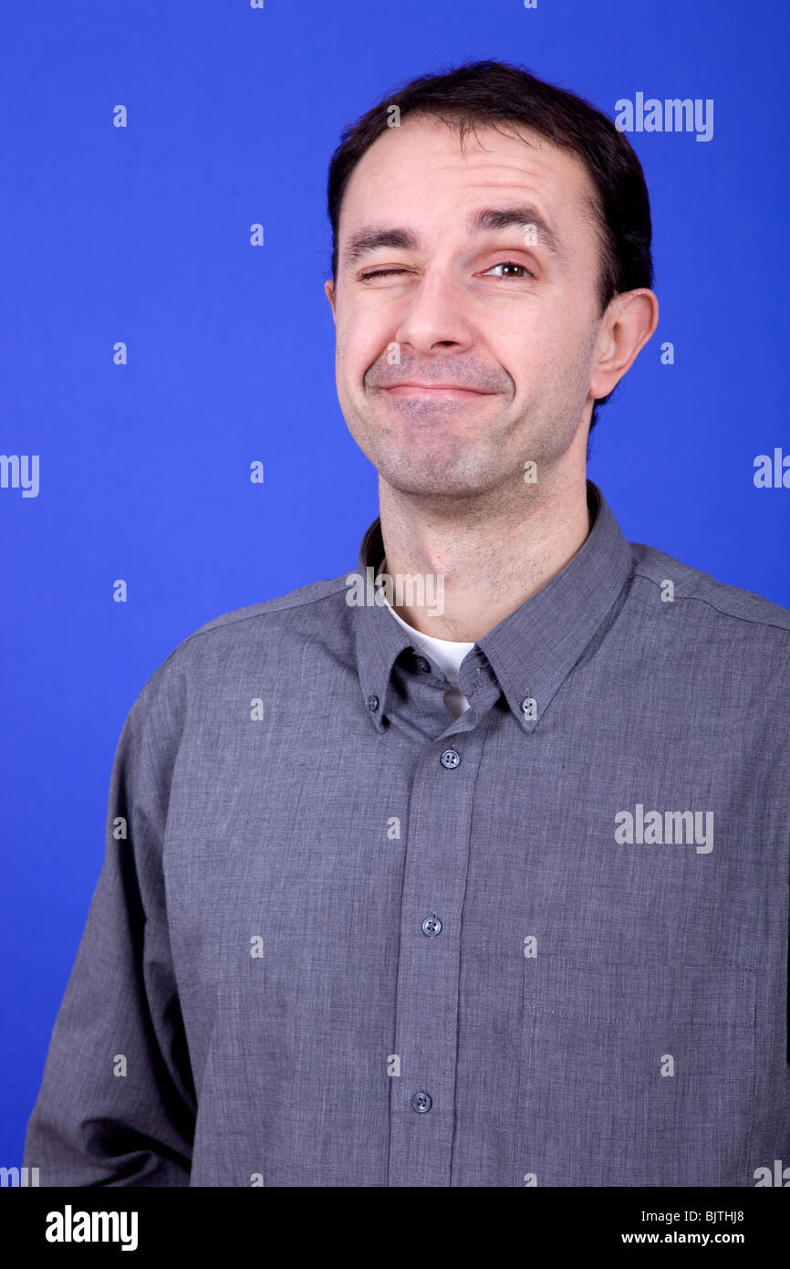 an silly young man portrait over a blue background Stock Photo - Alamy