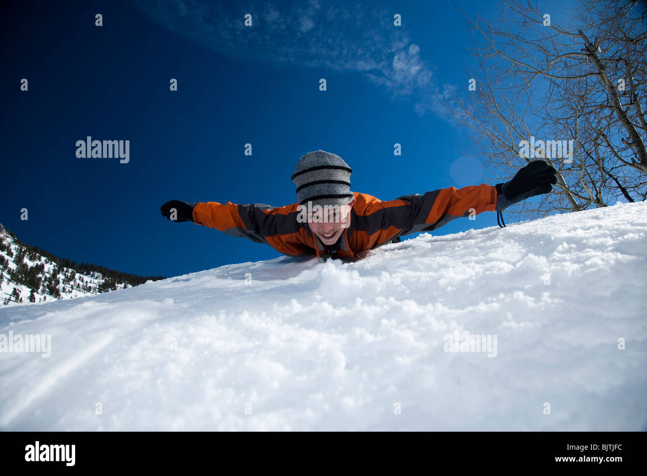 Boy sliding on stomach Stock Photo - Alamy