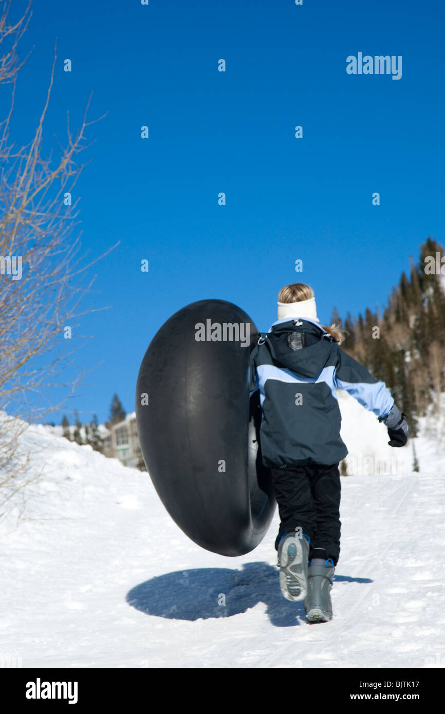 Kid walking with inner tube Stock Photo - Alamy