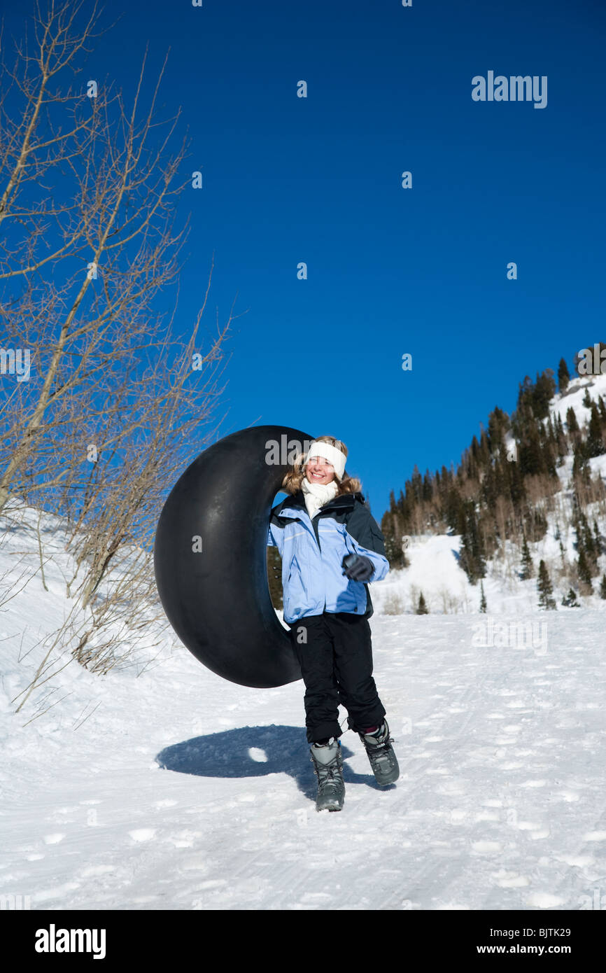 Girl walking with inner tube Stock Photo - Alamy
