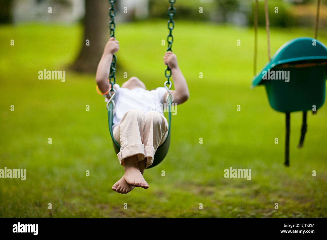 Leaning back on swing hi-res stock photography and images - Alamy