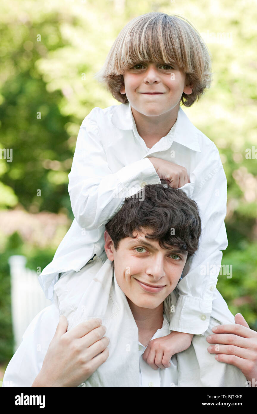 Young boy on shoulders of older boy Stock Photo - Alamy