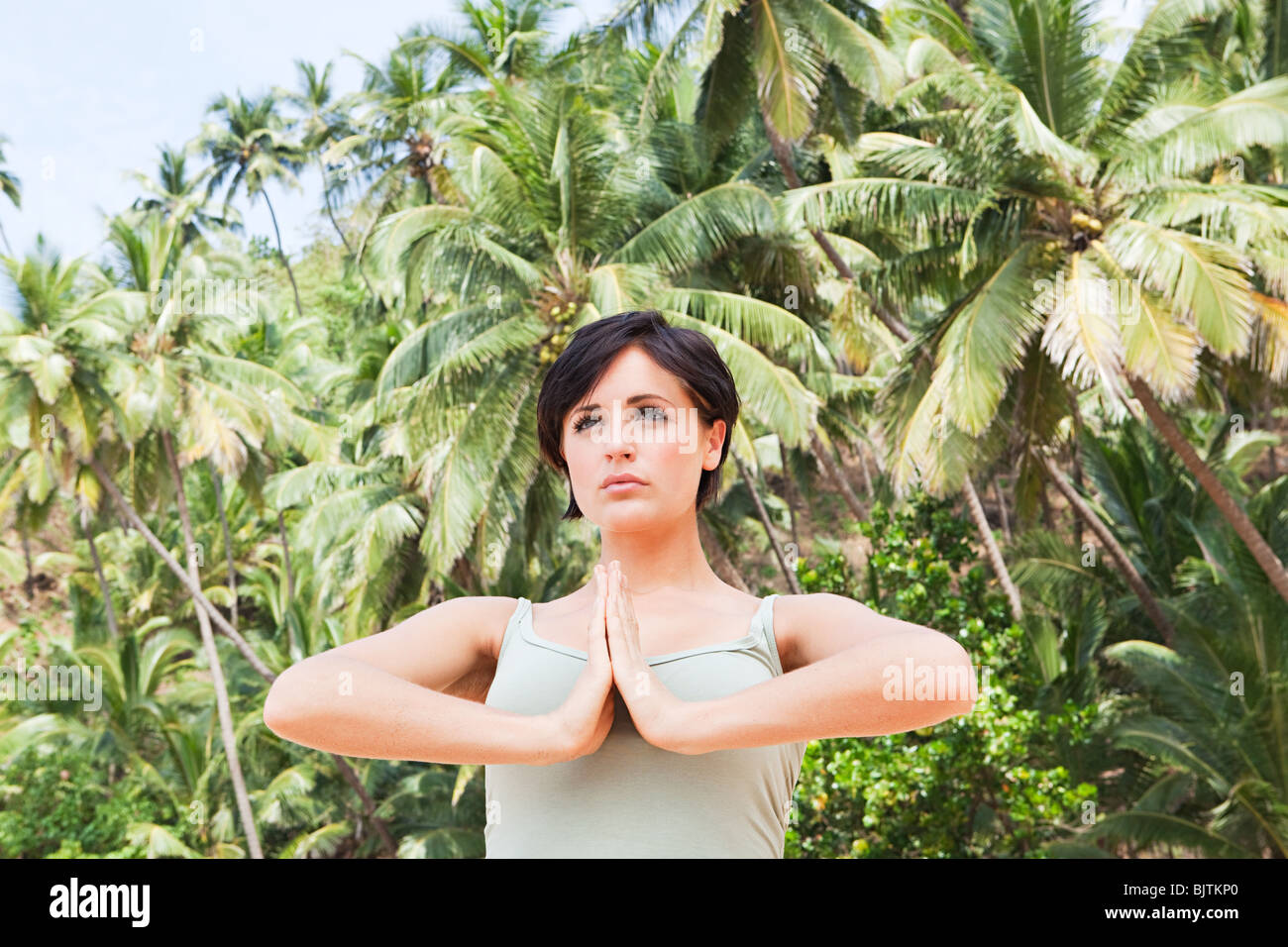 Woman in prayer pose Stock Photo - Alamy