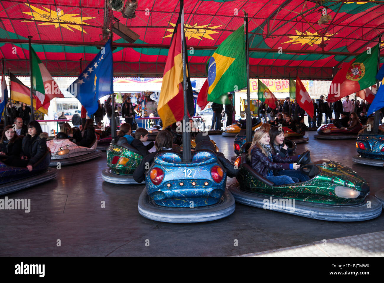 Teenagers having fun on a bumper car ride, dodgem cars. Charles Lupica ...